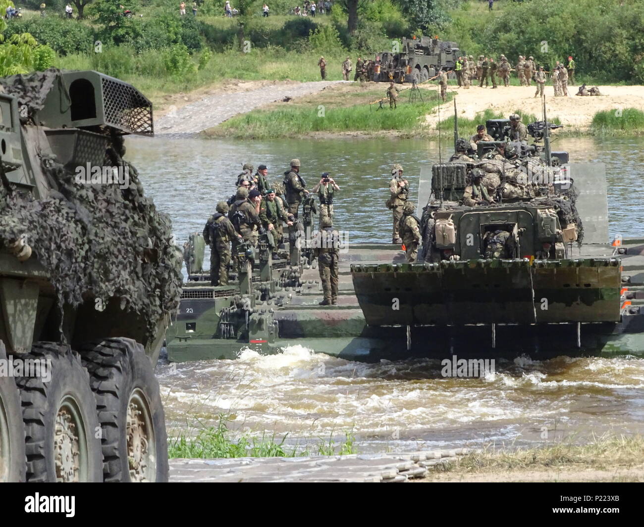 Troops cross a river on military M3 ferry during Sabre Strike, a large ...