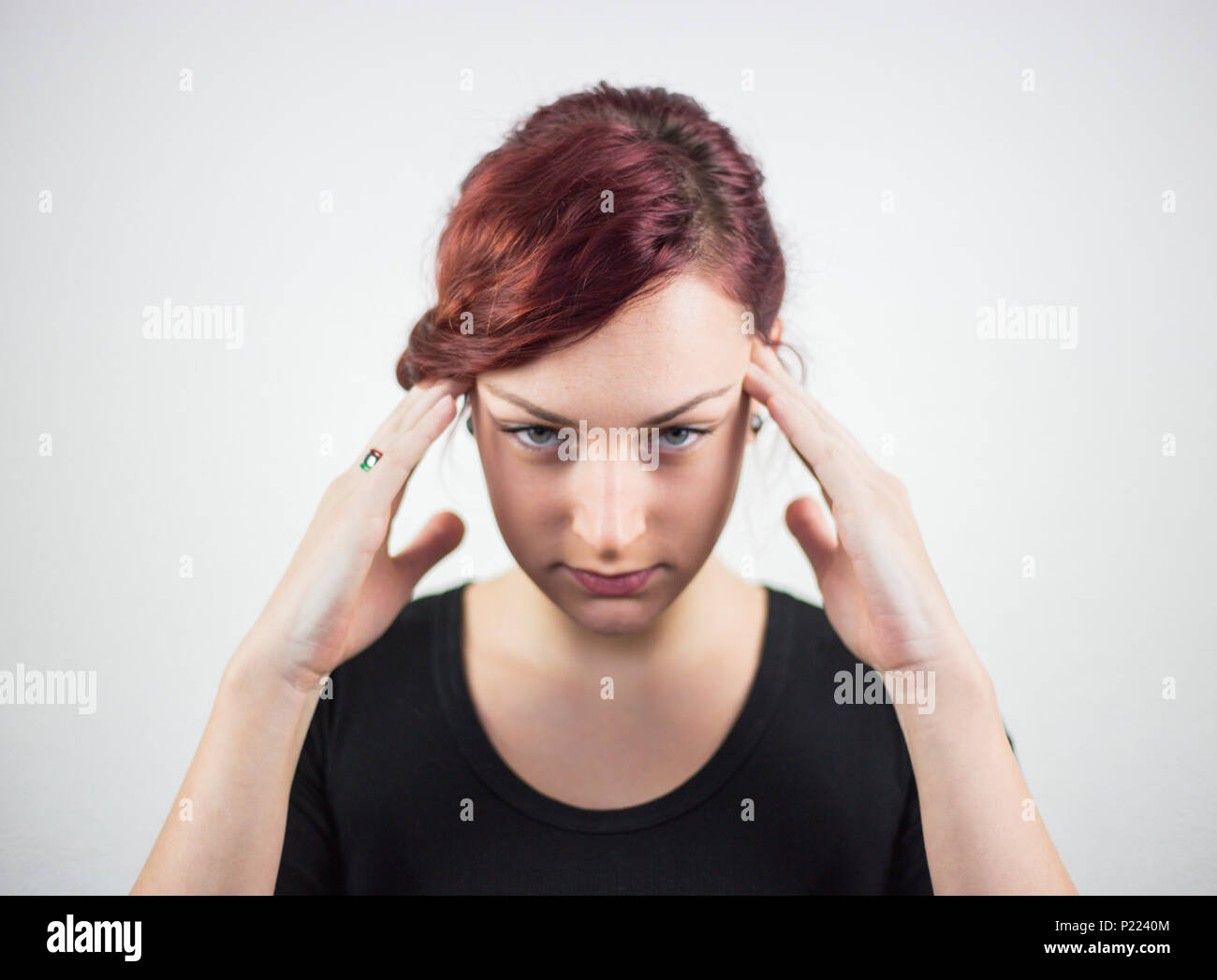 A young girl with facial expression, and hands shows that the pain is ...