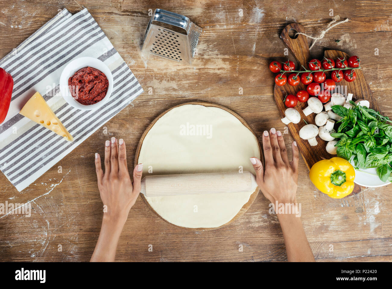 Top view of female hands rolling pizza dough with pin on table Stock ...
