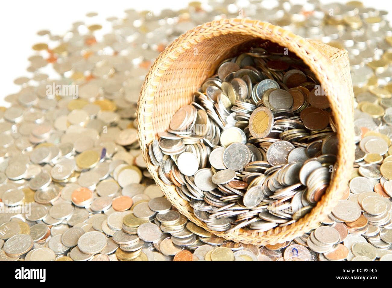 Saving money concept of collecting coins in a basket with coins ...