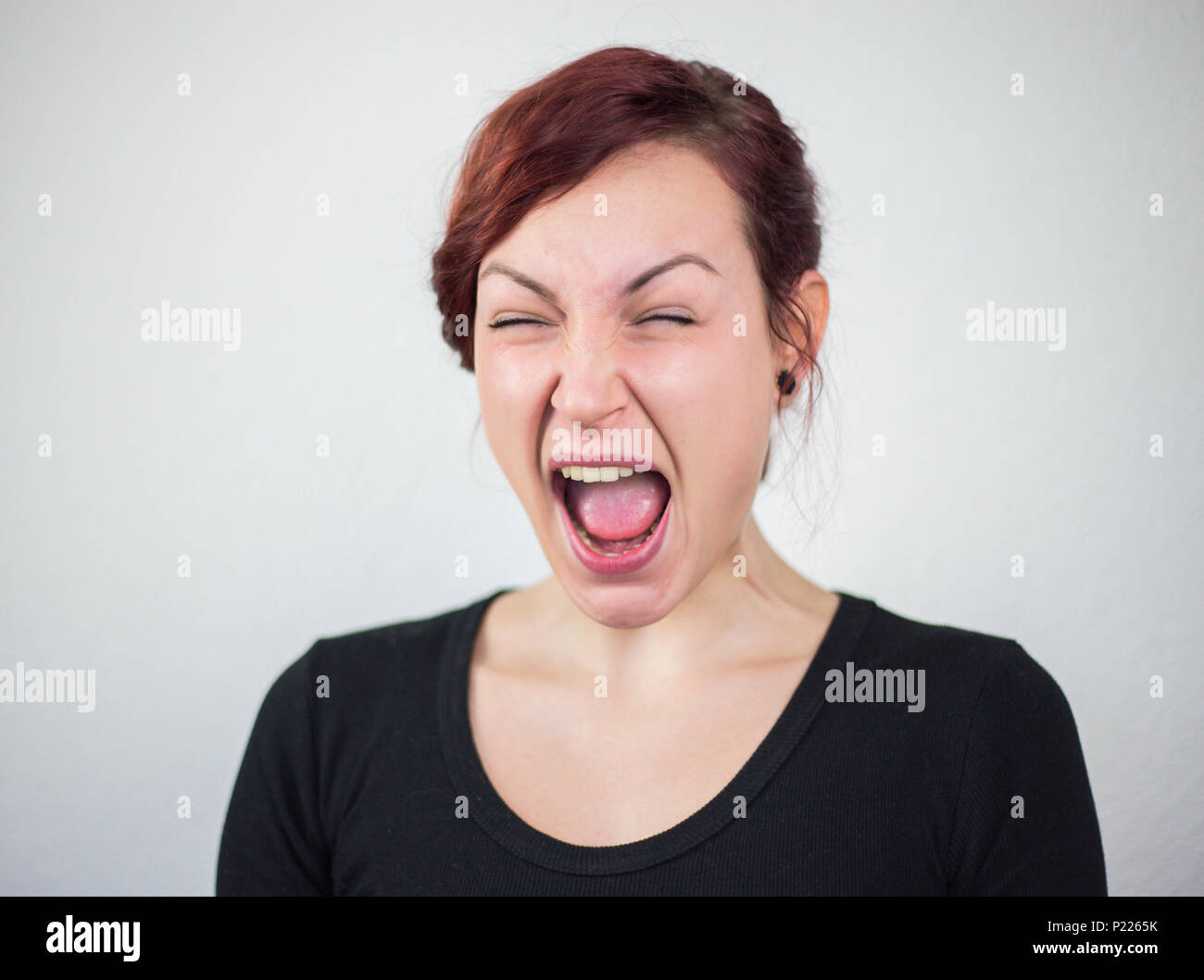 Young girl, screaming, white background, studio, facial expressions ...