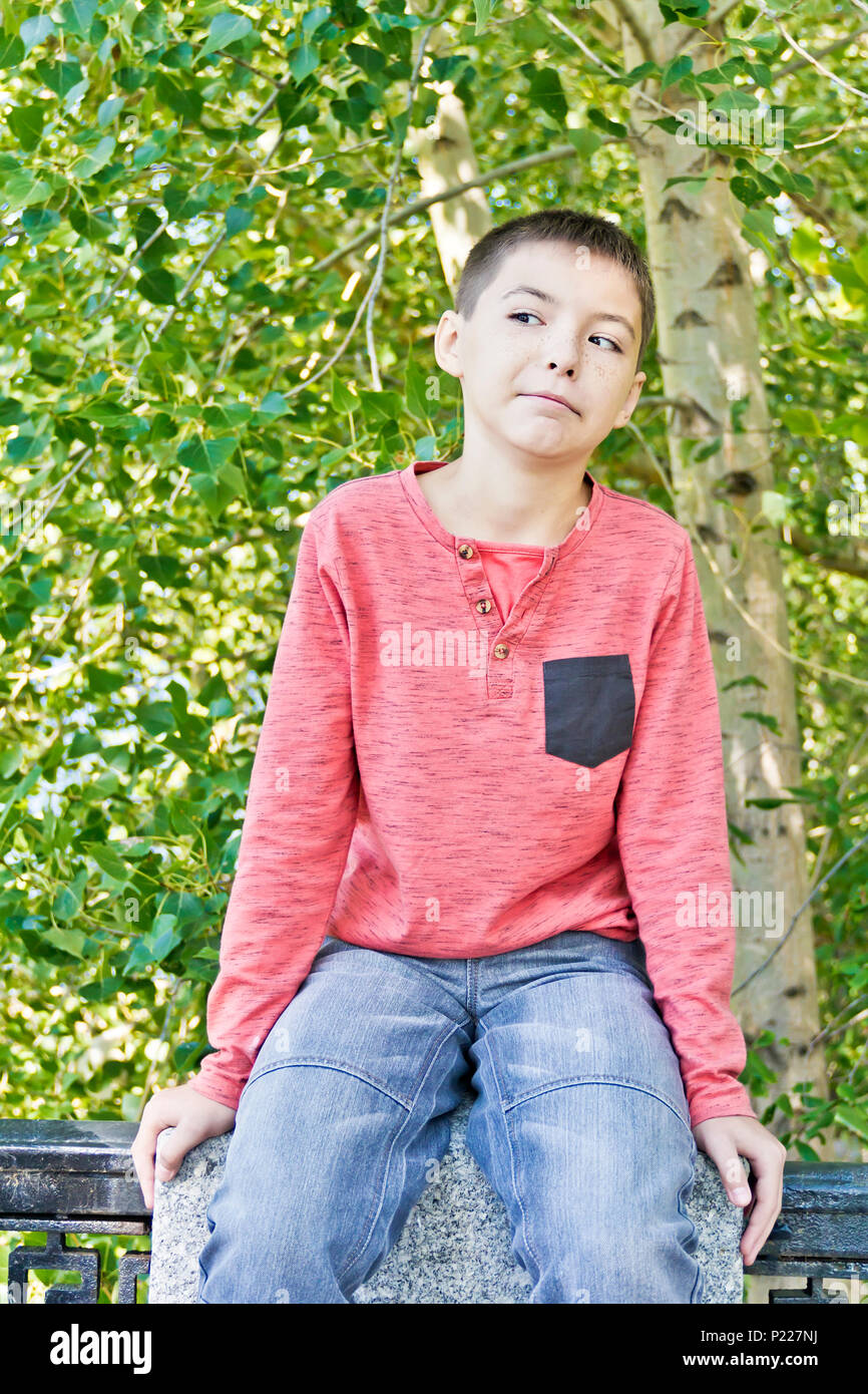 Grimace teenager boy in pink on green background Stock Photo - Alamy