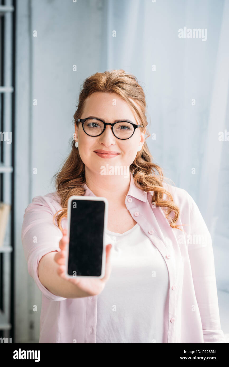 beautiful woman showing smartphone at home Stock Photo - Alamy