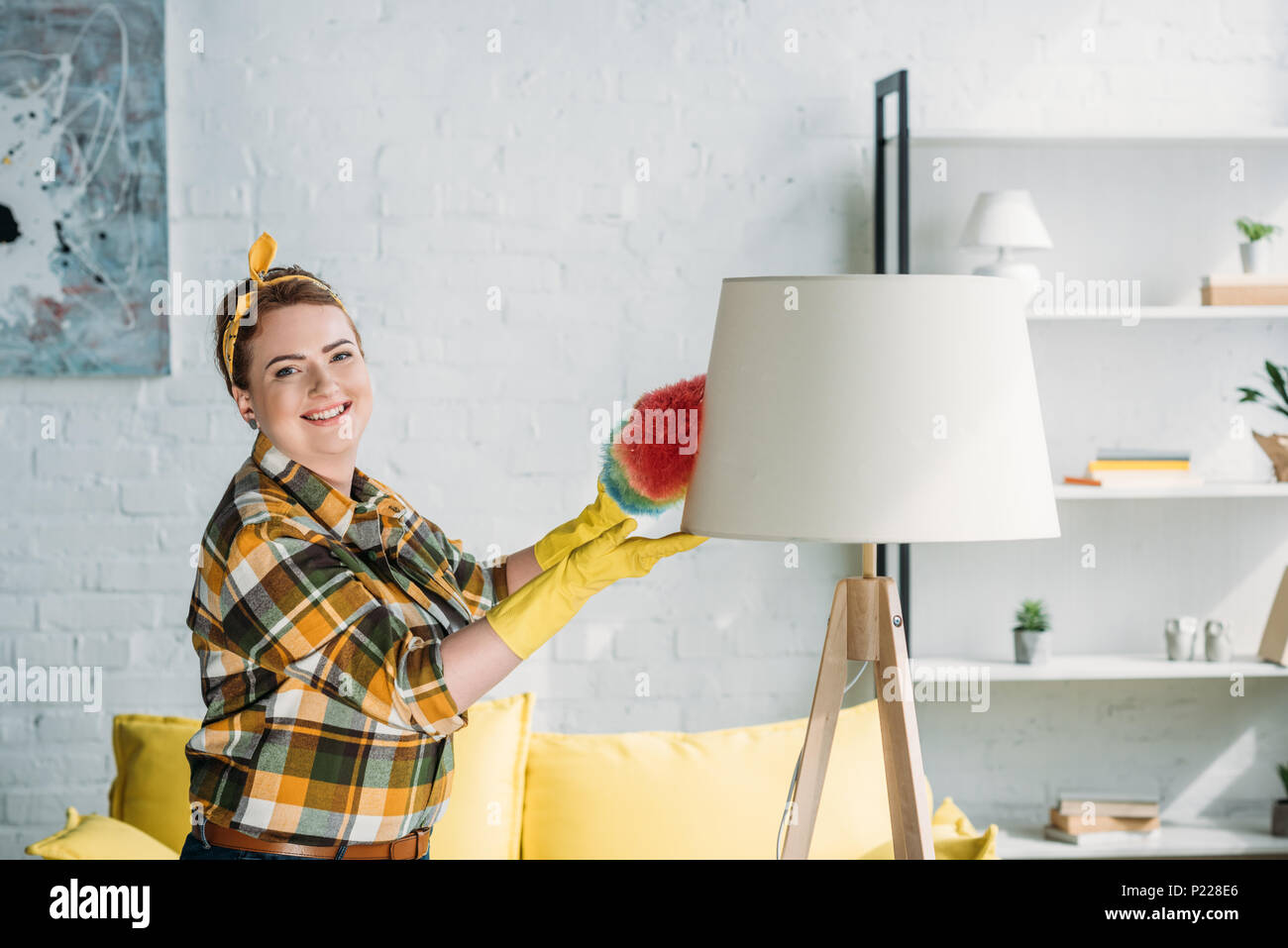 Beautiful woman dusting lamp hi-res stock photography and images - Alamy