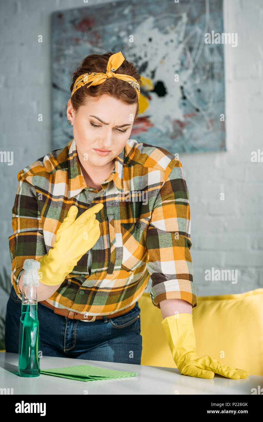 beautiful woman checking dust on table for cleaning at home Stock Photo ...
