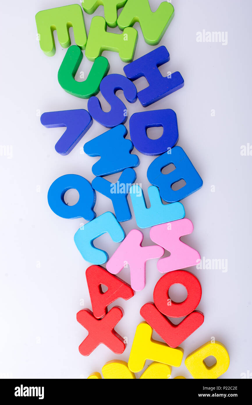 Colorful alphabet letter blocks scattered randomly on white background ...