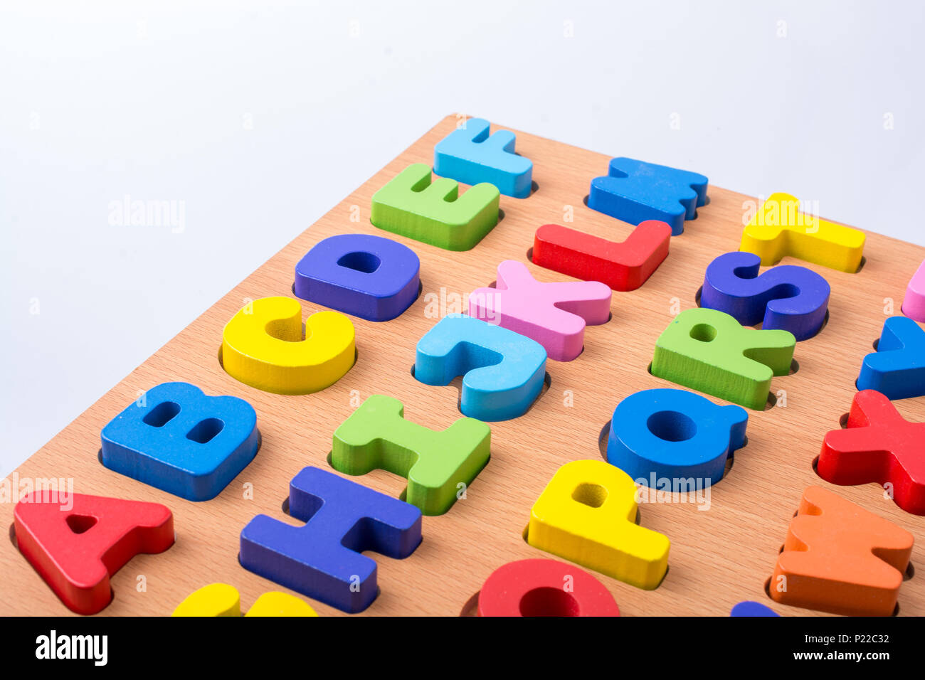 Colorful letter blocks on board on white background Stock Photo - Alamy