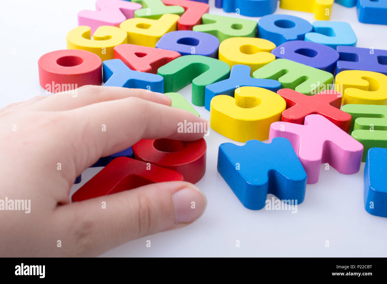 Colorful alphabet letter blocks scattered randomly on white background ...