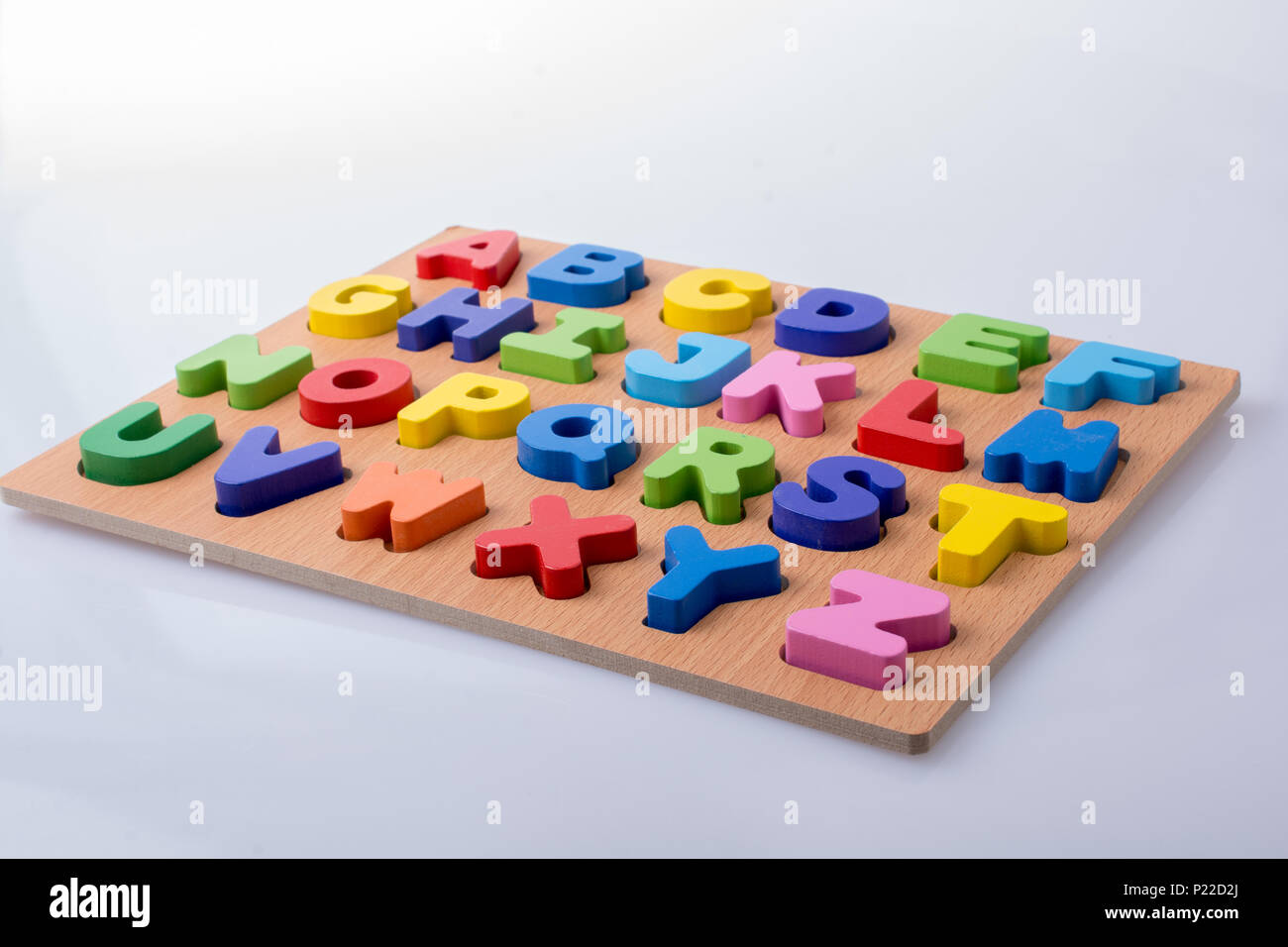 Colorful letter blocks on board on white background Stock Photo - Alamy