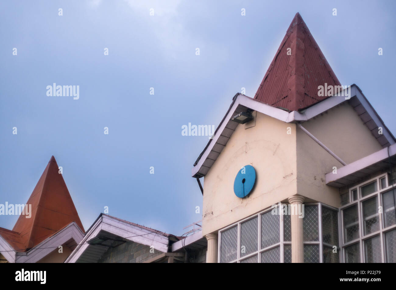 Tower of building with conical roof shot against a blue cloudy s Stock ...
