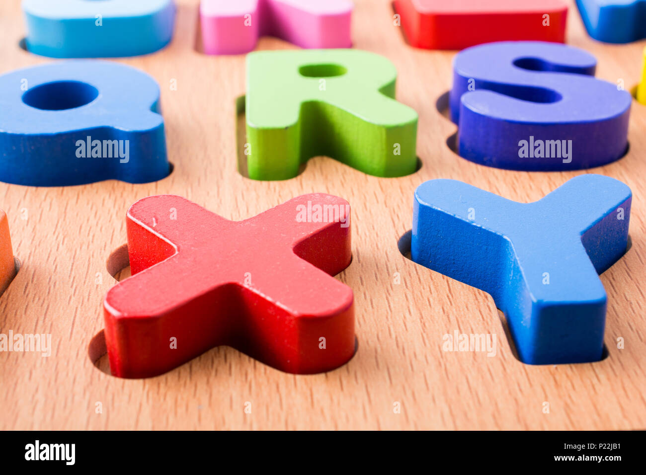 Colorful letter blocks on board on white background Stock Photo - Alamy