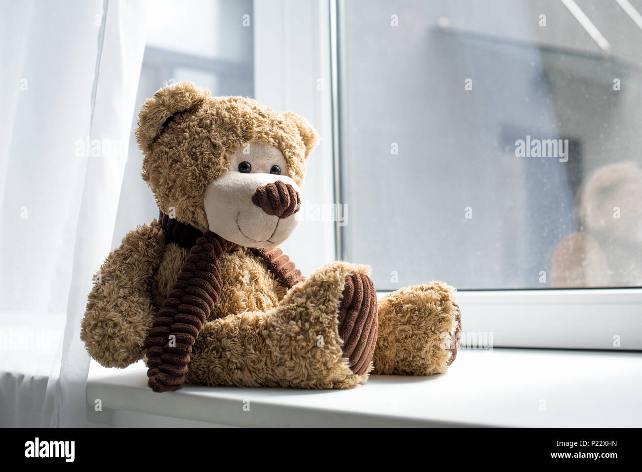 close up view of cute teddy bear on window sill Stock Photo - Alamy