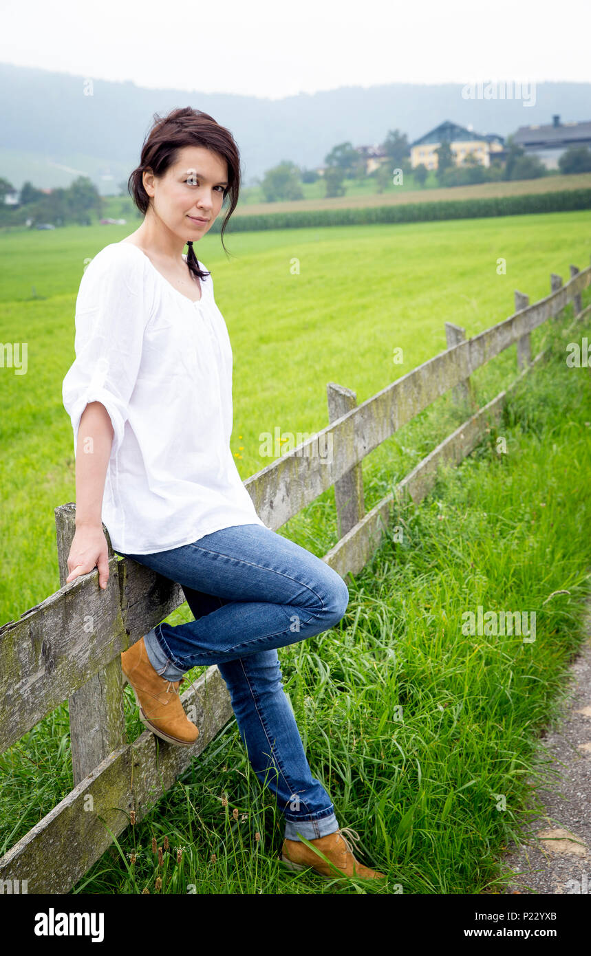 Woman on wooden fence hi-res stock photography and images - Alamy