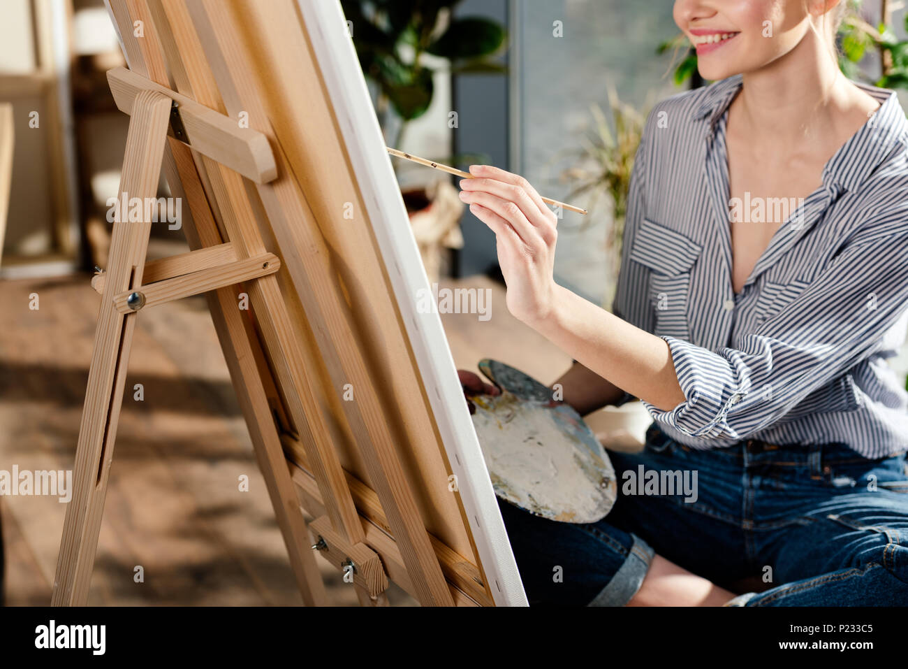 cropped image of young female artist painting on easel Stock Photo - Alamy