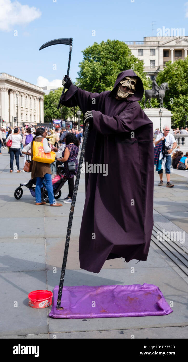 Grim Reaper living statue busker in Trafalgar Square London UK Stock ...