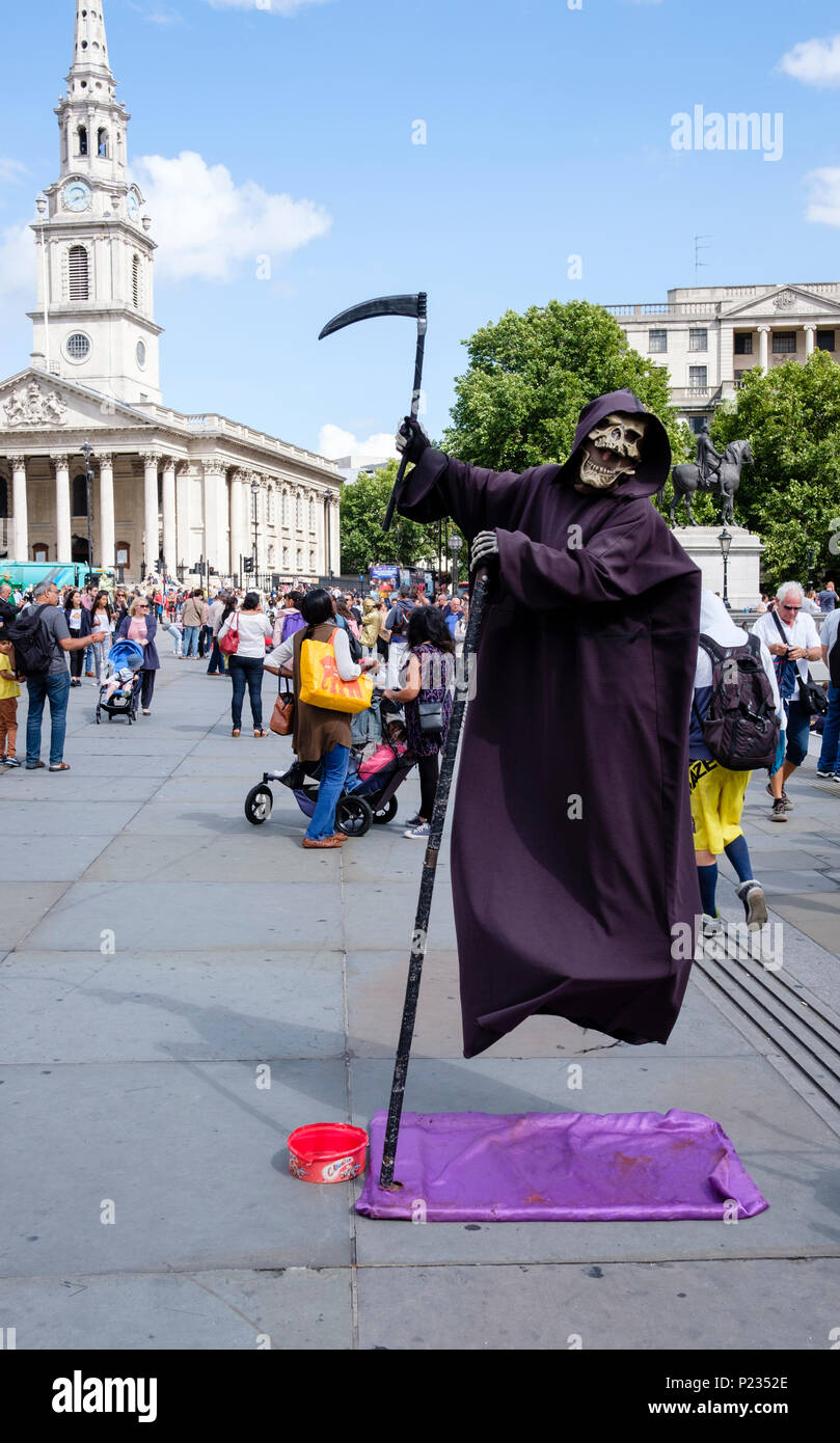 Grim Reaper living statue busker in Trafalgar Square London UK Stock ...