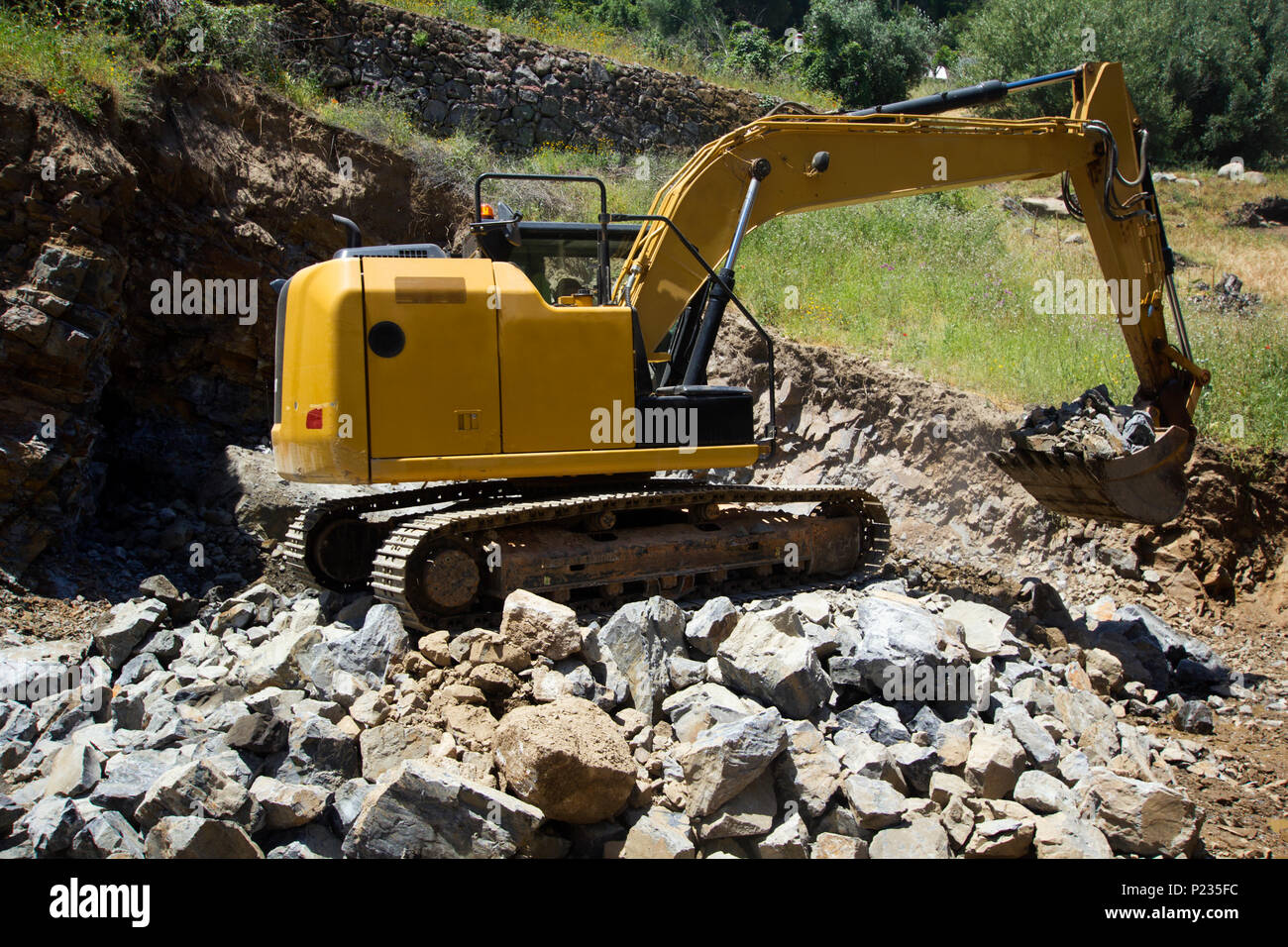 Digger at work preparing a site for house construction Stock Photo - Alamy