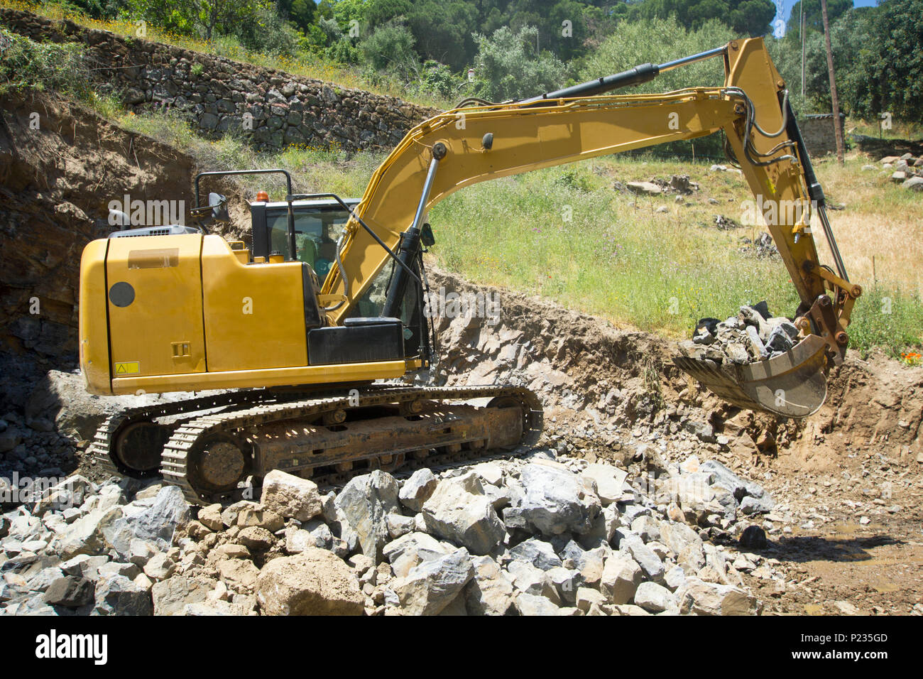 Digger at work preparing a site for house construction Stock Photo - Alamy