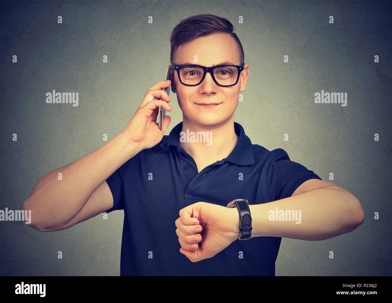 Business and time management concept. Man with wrist watch, talking on ...