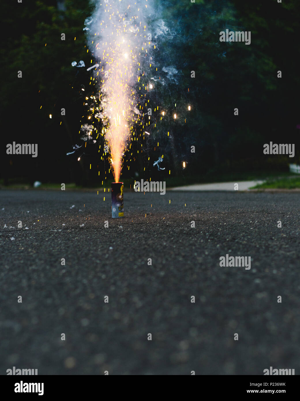 Small novelty cake fireworks exploding on a street at night Stock Photo ...