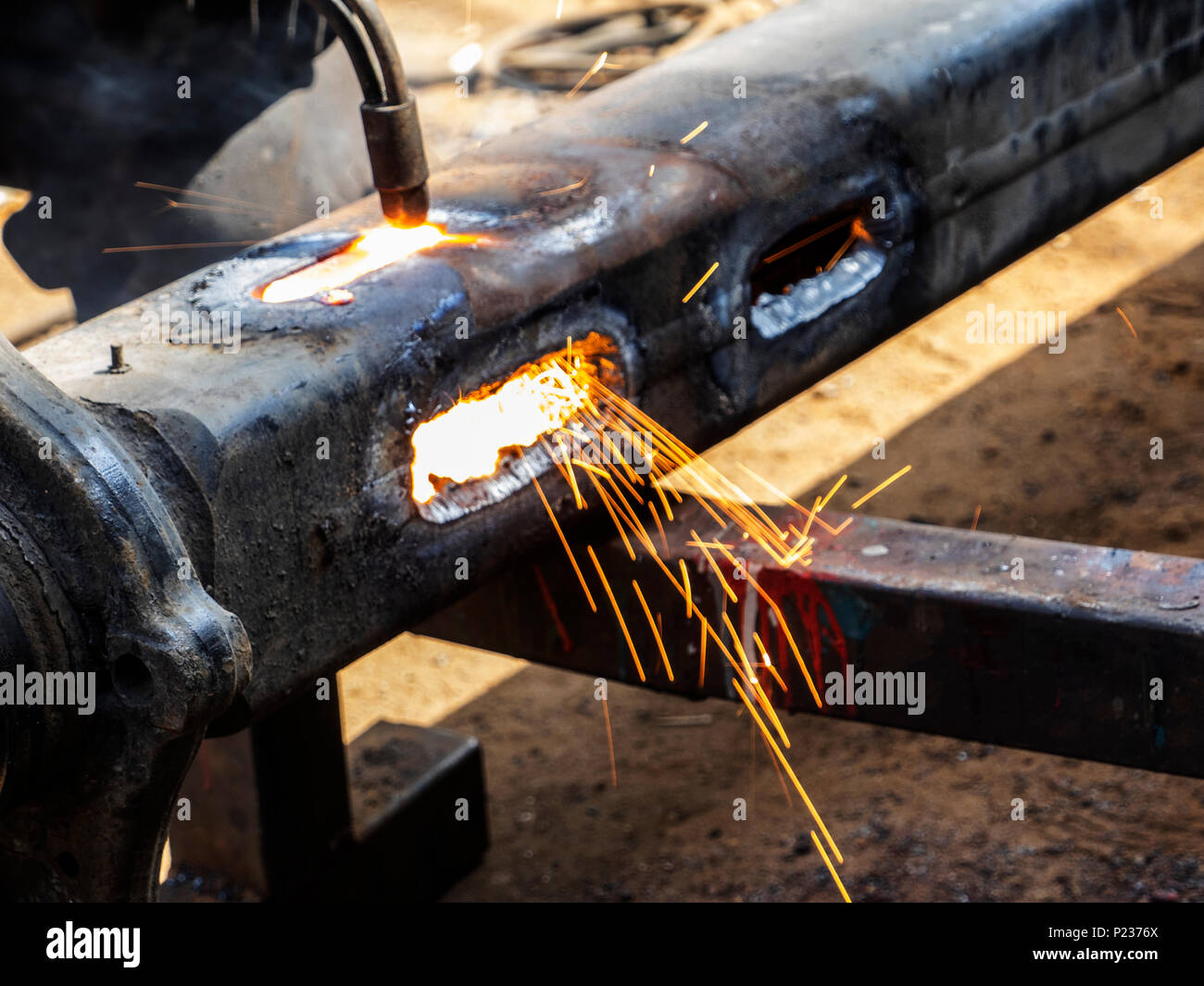Metal work. Man cuts a hole in a steel piece using gas welding Stock ...