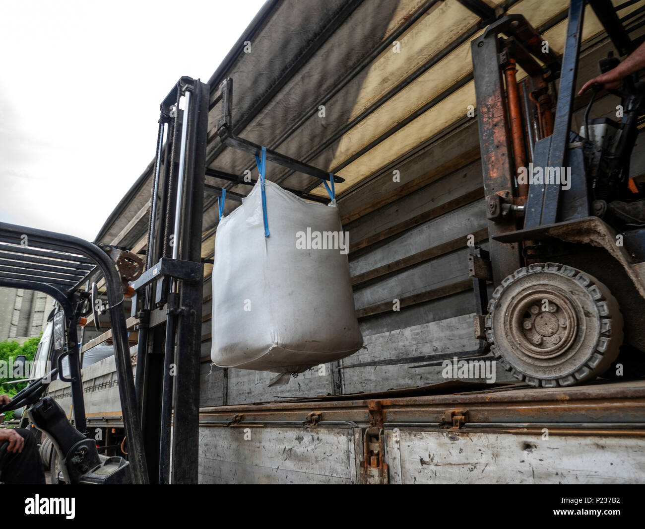 Loading big bags into the truck Stock Photo - Alamy