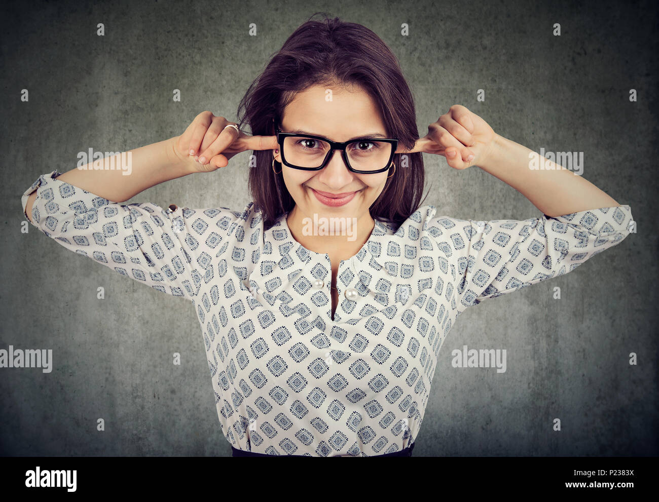 Sly funny woman plugging her ears with fingers ignoring everyone Stock ...