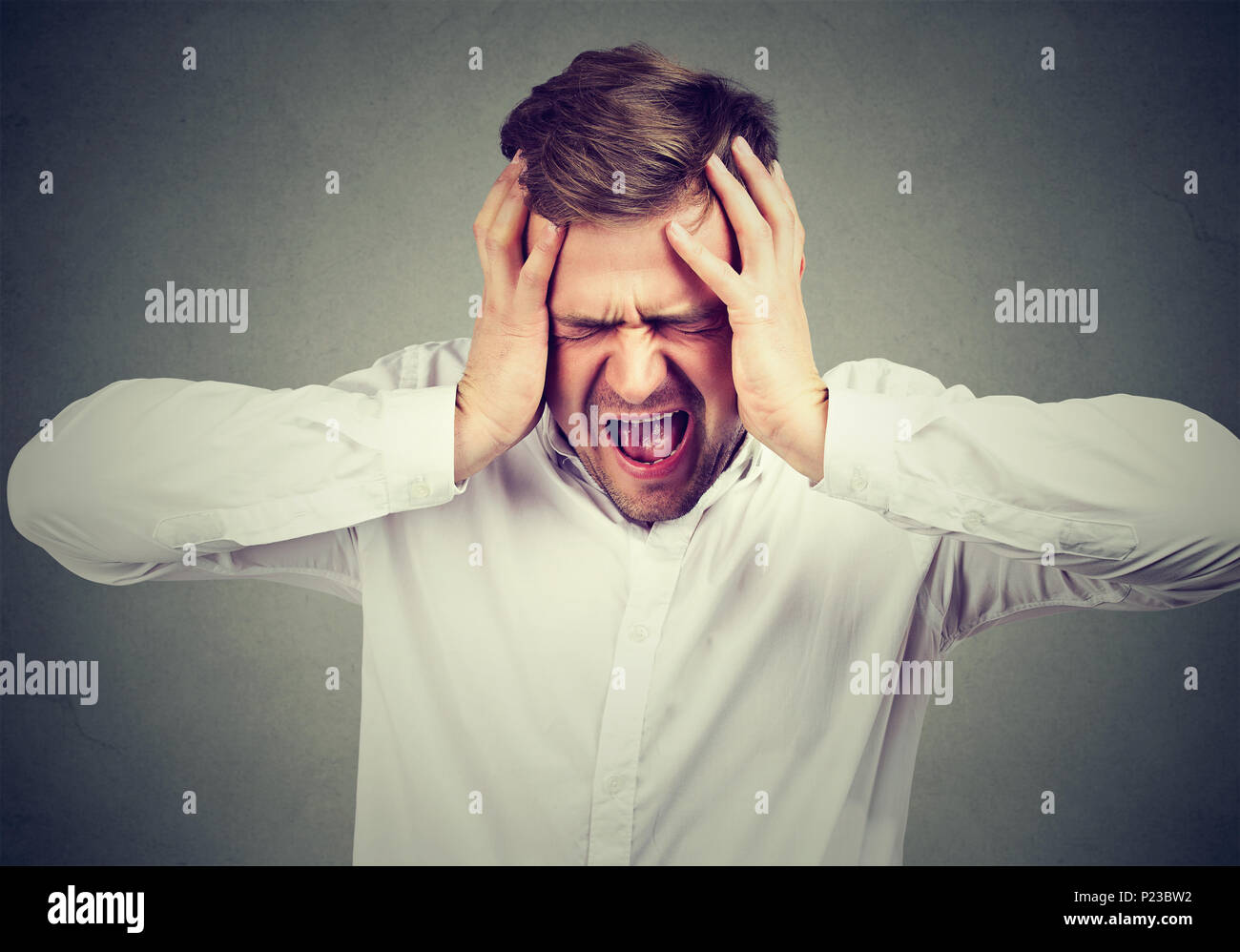 Squeeze your head with your hands hi-res stock photography and images ...