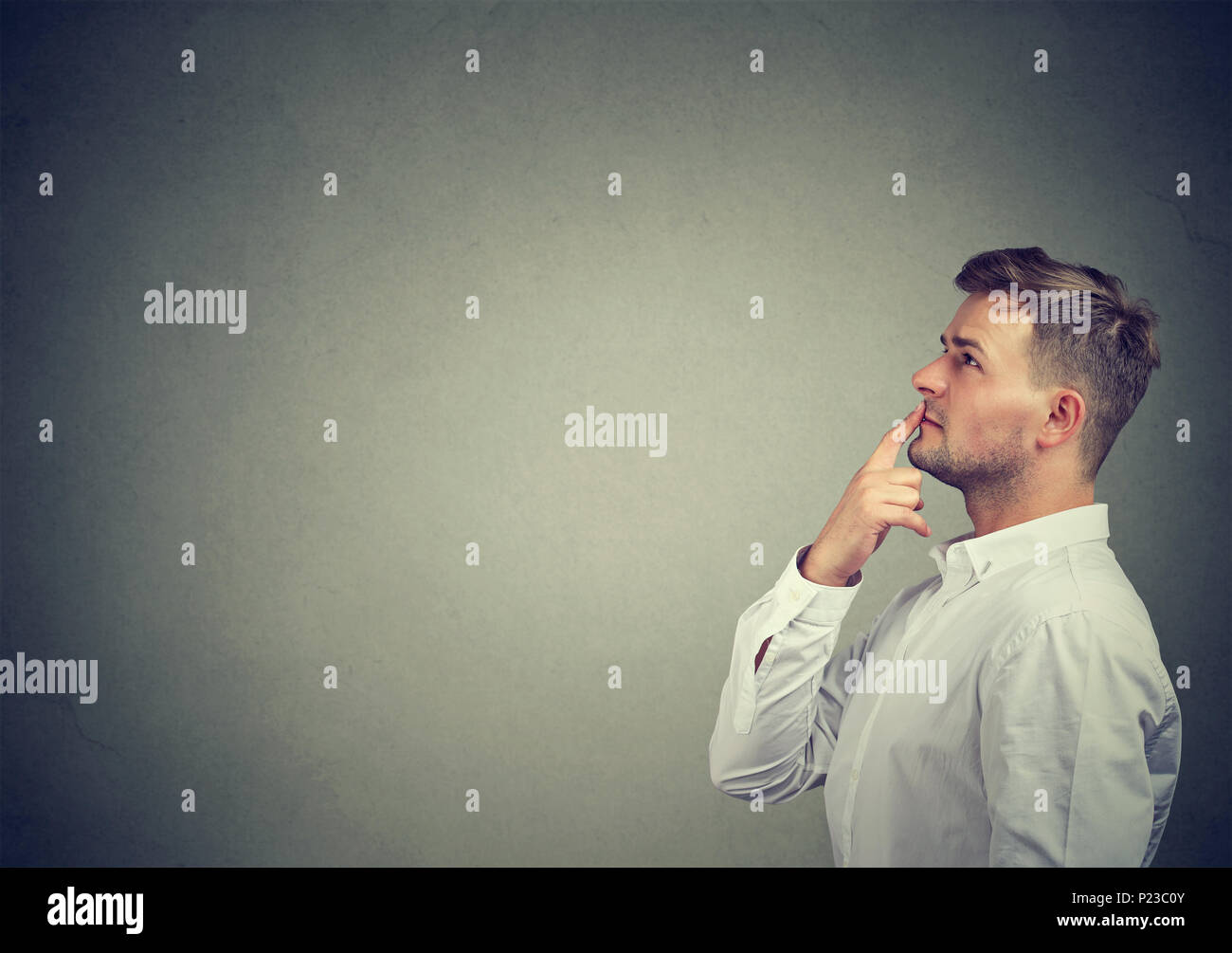 Pondering young man hi-res stock photography and images - Alamy