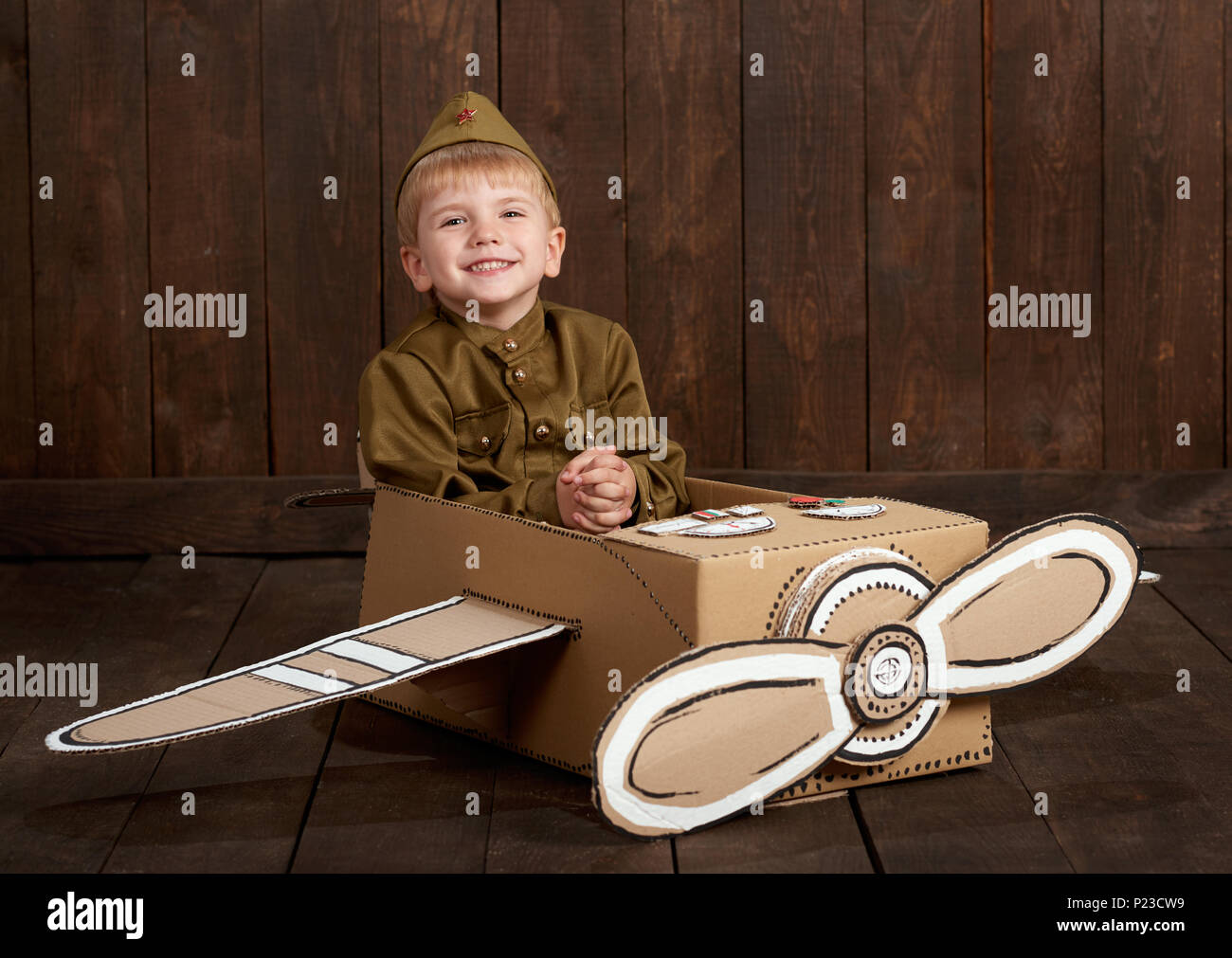 children boy are dressed as soldier in retro military uniforms sit in ...