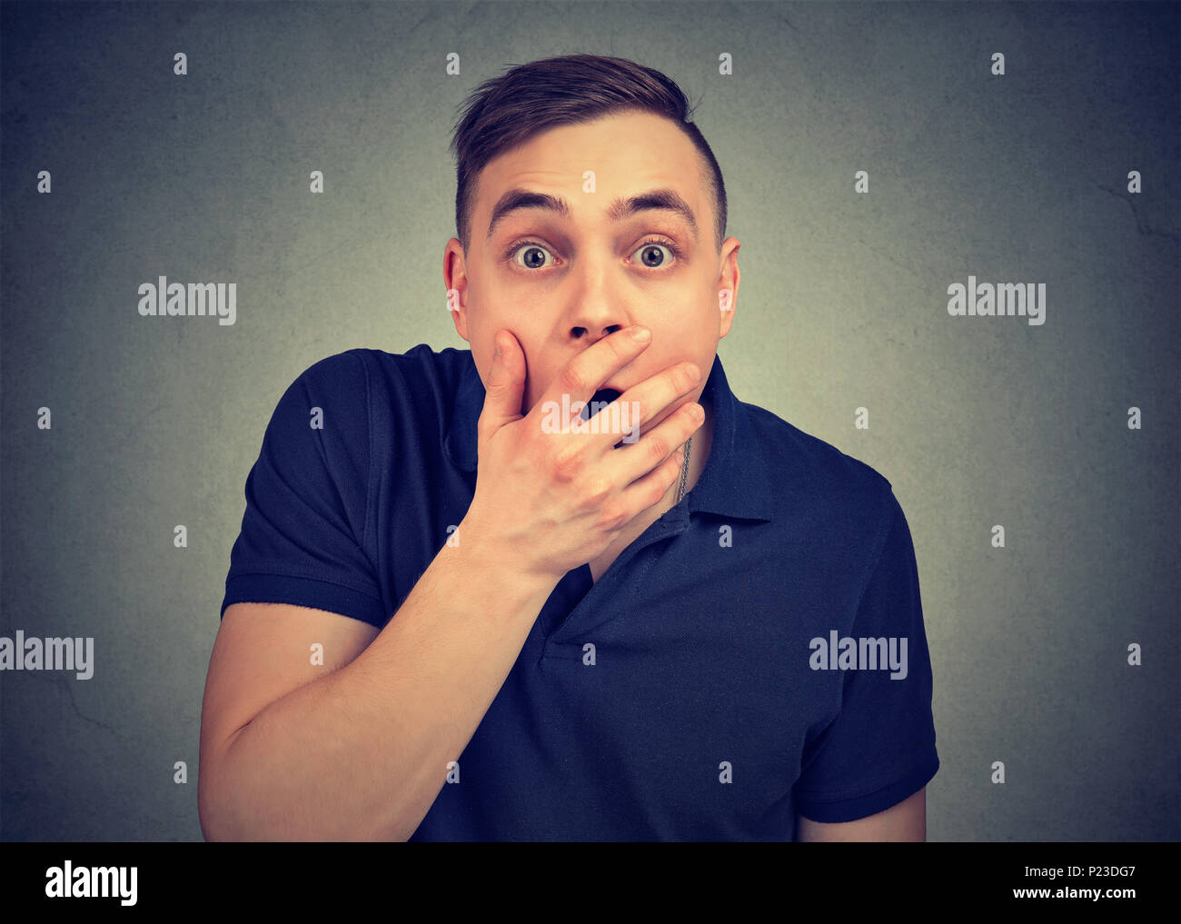 Concerned scared shocked man isolated on gray background Stock Photo ...