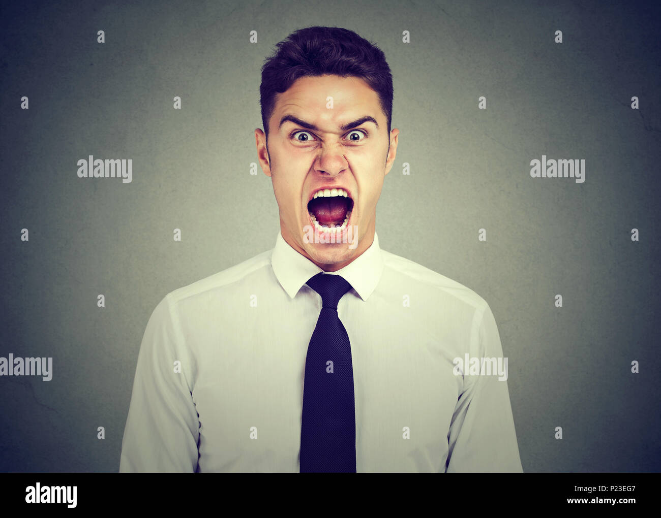portrait of young angry business man screaming Stock Photo - Alamy