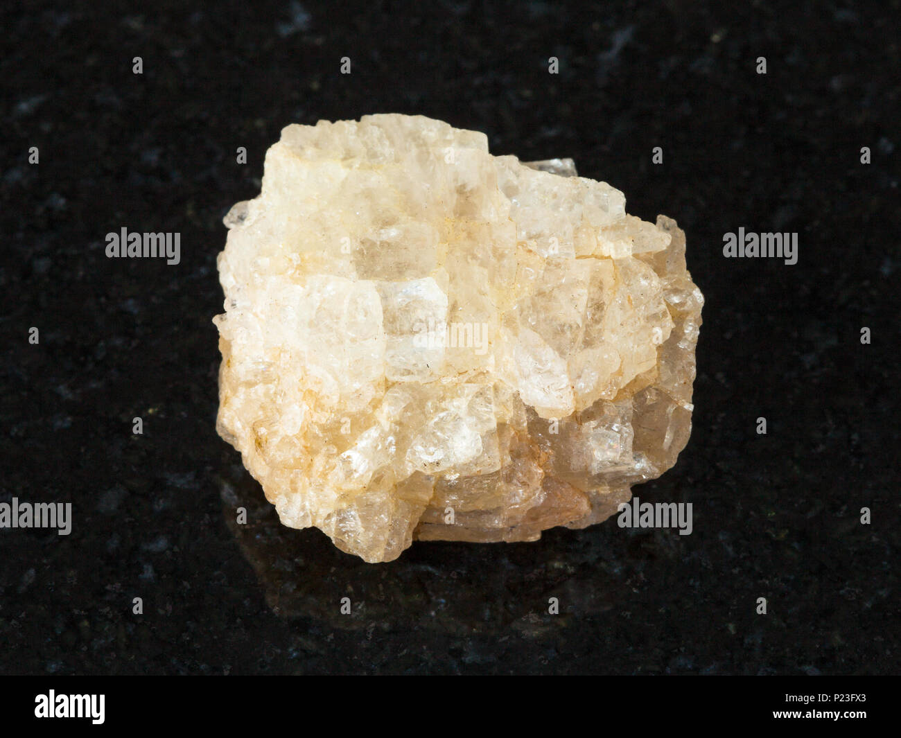 macro shooting of natural mineral - raw Topaz stone on black granite ...