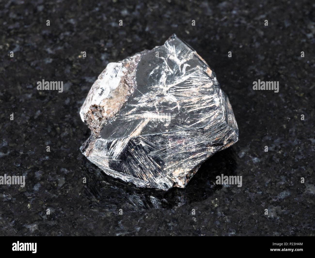 macro shooting of natural mineral - Hematite crystal on black granite ...