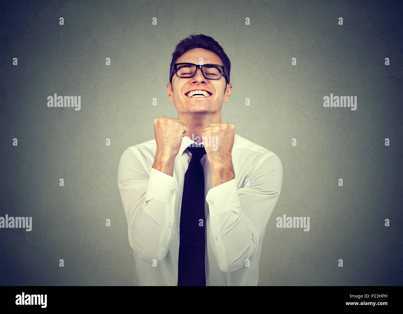 Successful business man with fists pumped celebrating success isolated ...