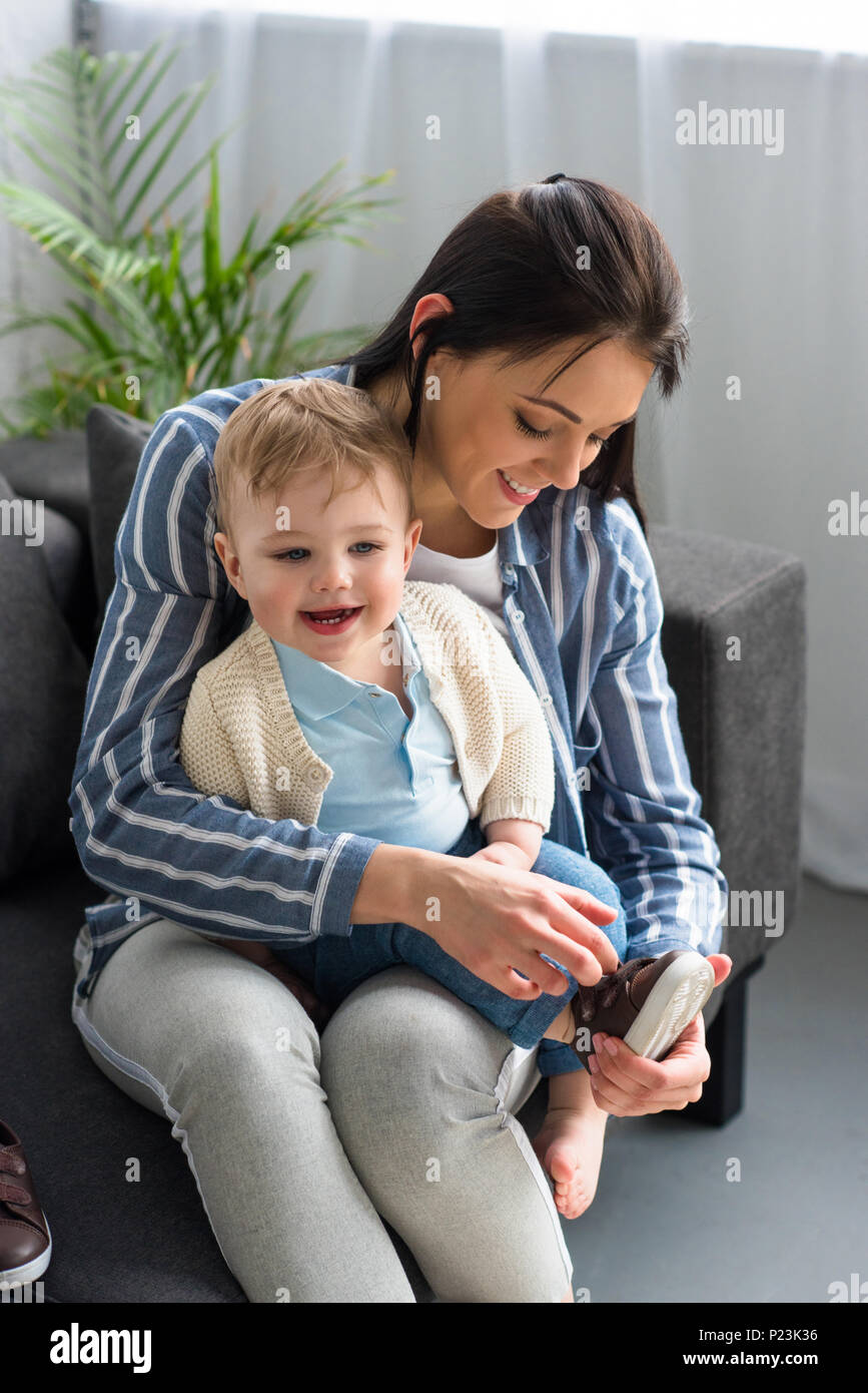 Mom dressing baby hi-res stock photography and images - Alamy