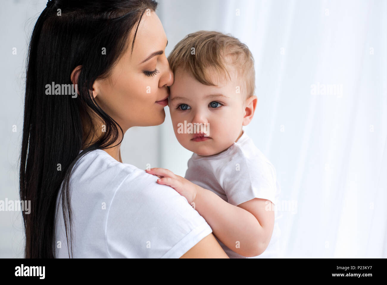 smiling tender mother holding cute baby boy in hands at home Stock Photo - Alamy