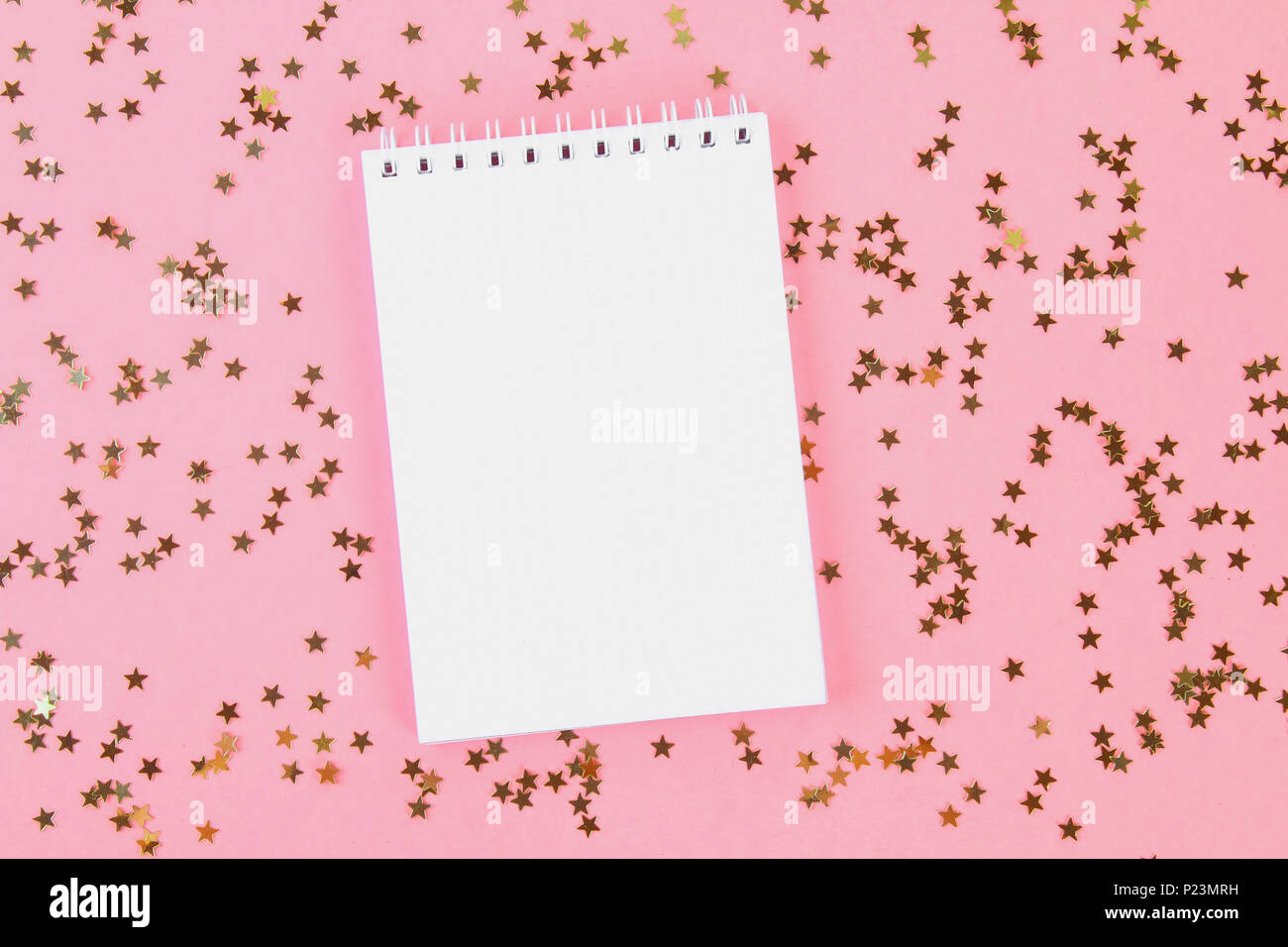 An empty pad on a pastel background surrounded by shiny decorative ...