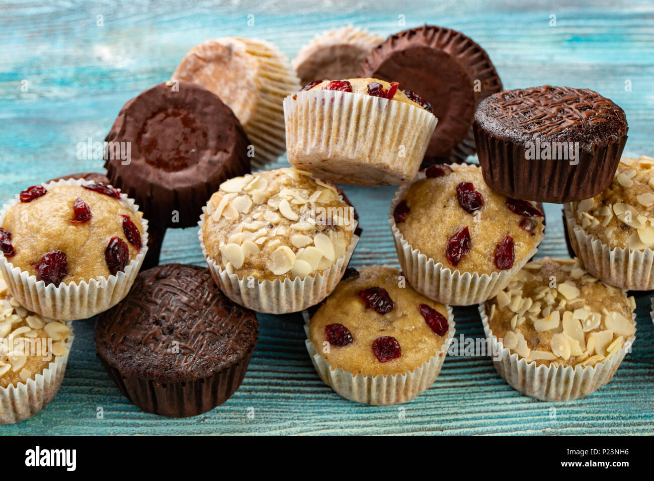 Pile of various different muffin cupcakes on blue wooden background ...