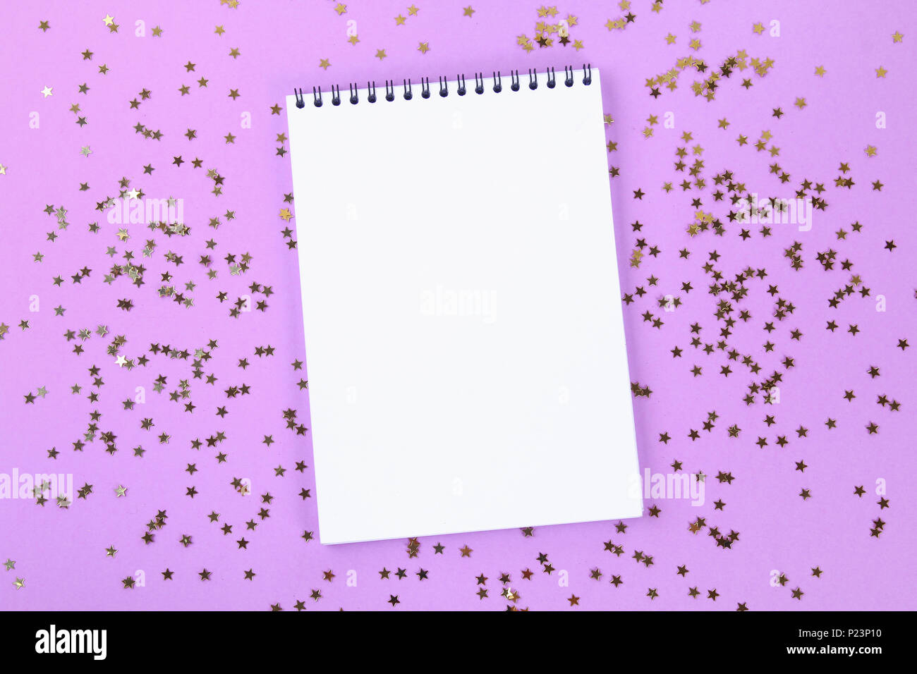 An empty pad on a pastel background surrounded by shiny decorative ...