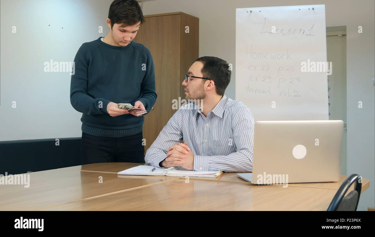 Male teacher take money from student for passing exam Stock Photo - Alamy