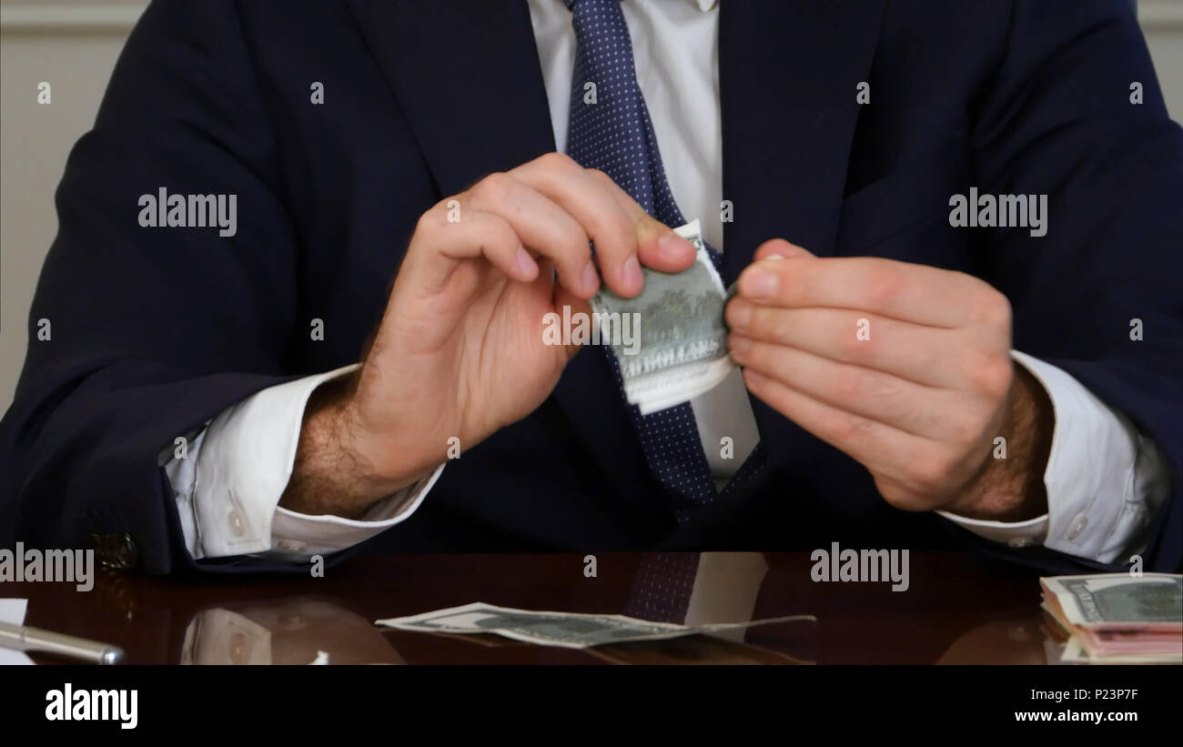 Hands tearing money hi-res stock photography and images - Alamy