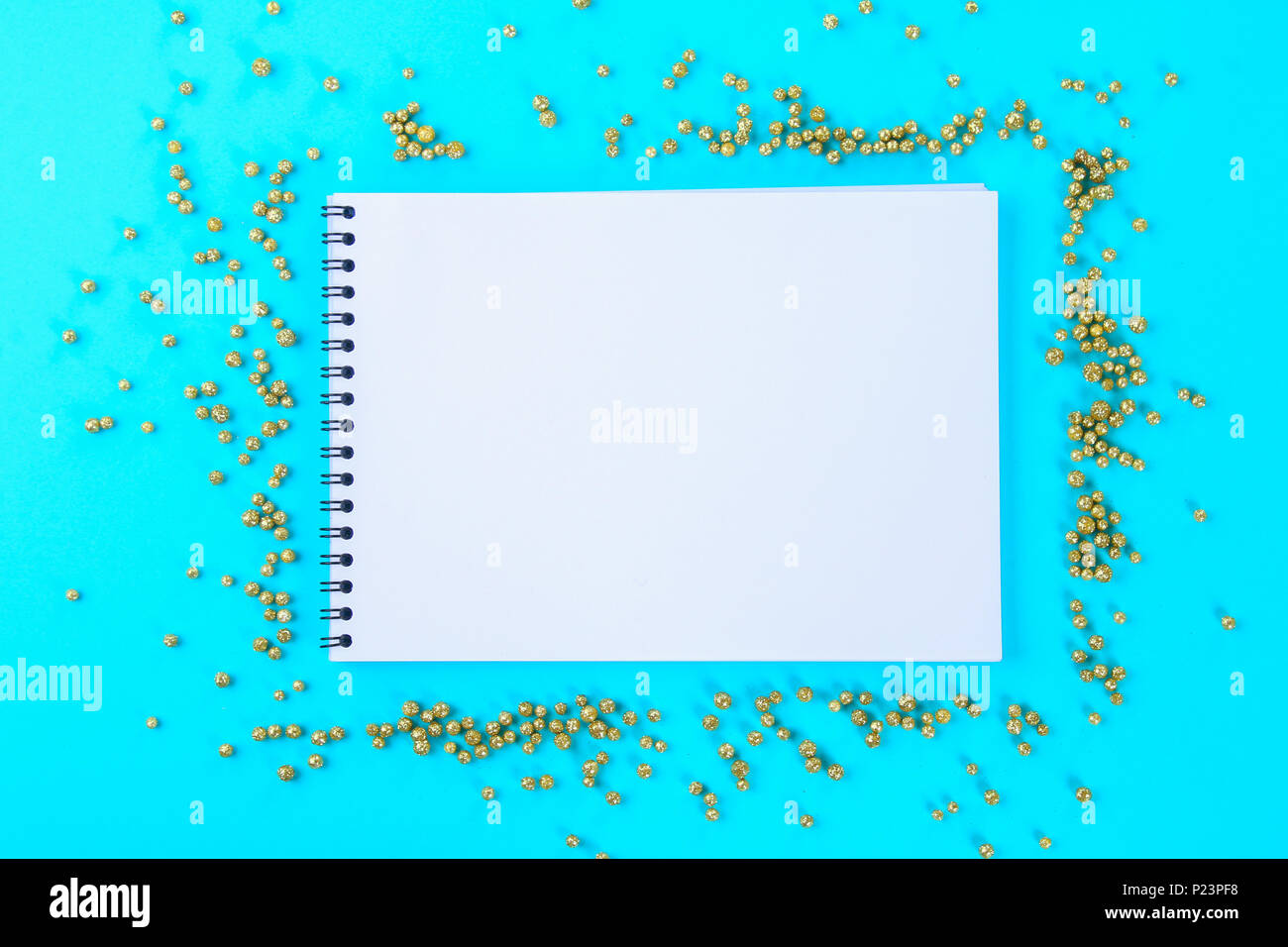 An empty pad on a pastel background surrounded by shiny decorative ...