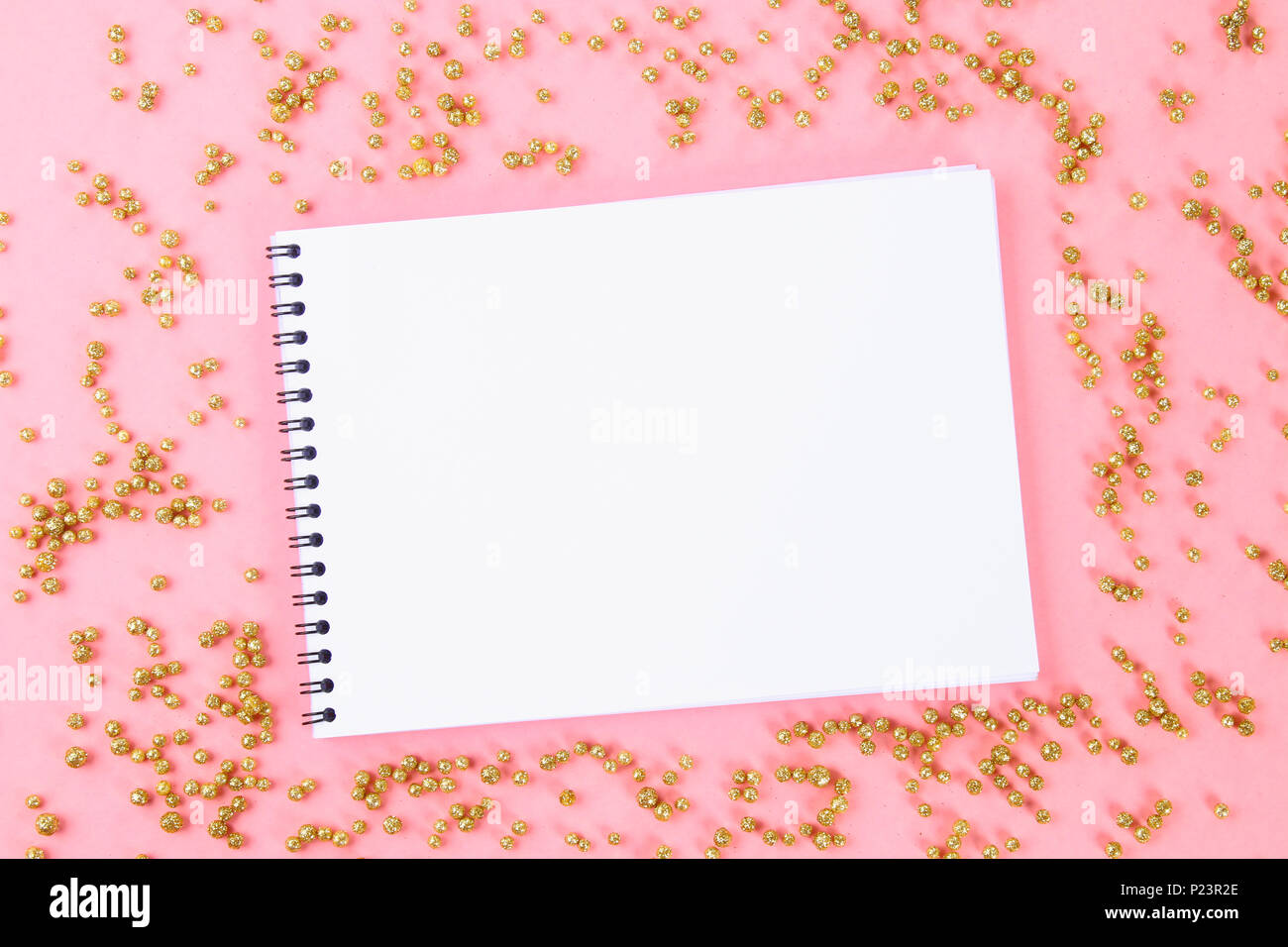 An empty pad on a pastel background surrounded by shiny decorative ...