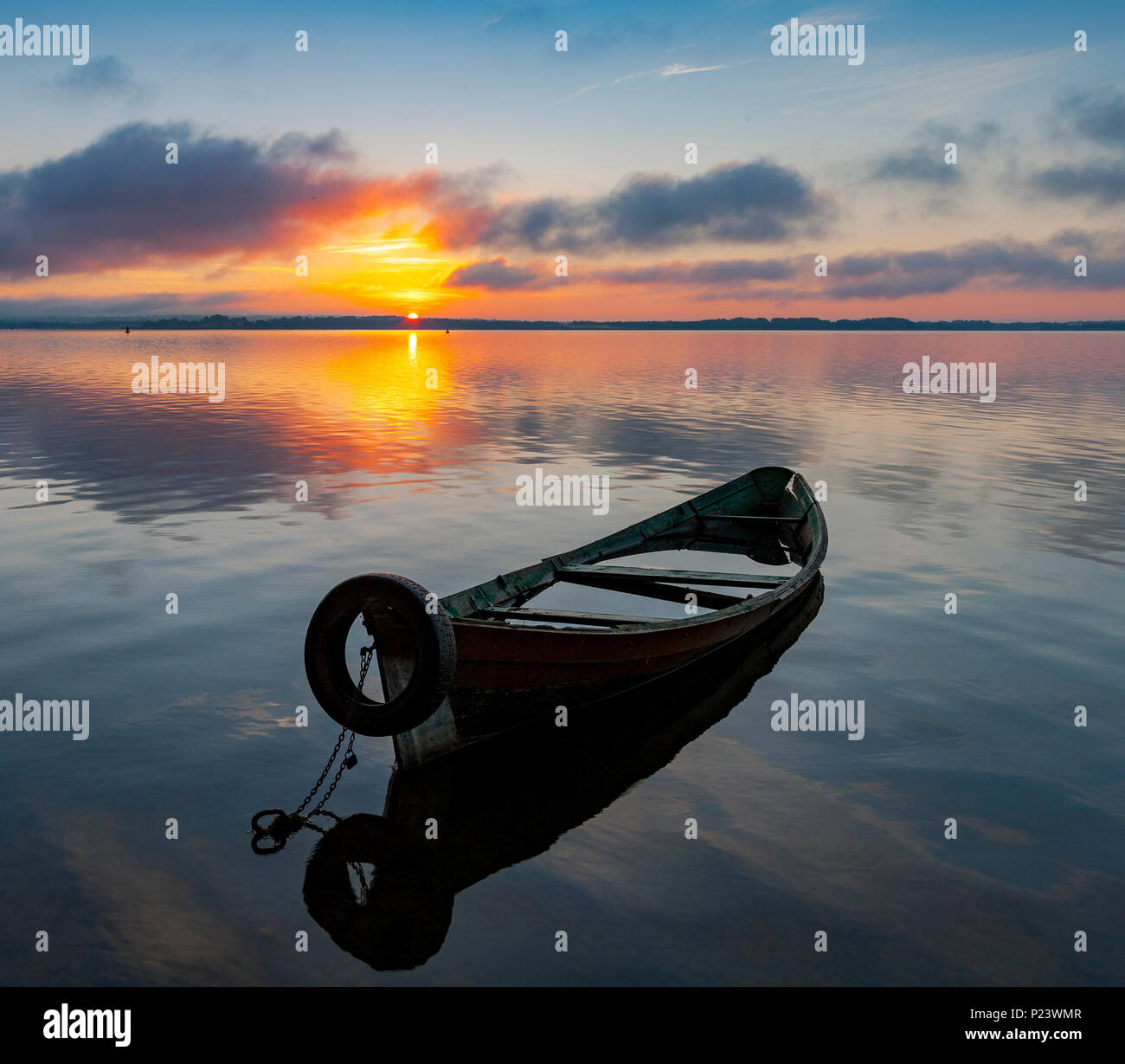 Sunrise on lake Seliger with an old fishing boat in the foreground, Ostashkov, Tver region ...