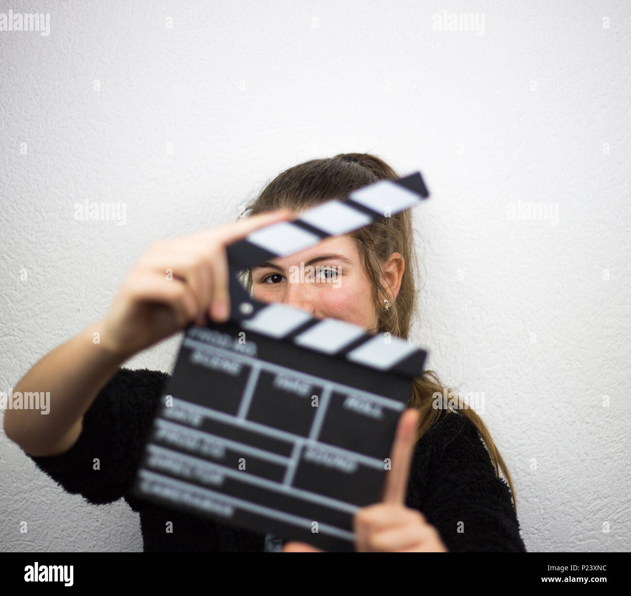 Start a movie scene with a movie clapper. Black and white in the studio ...
