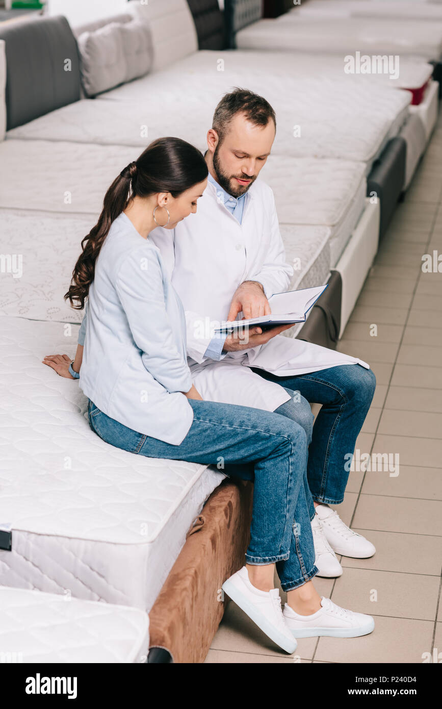 Woman helping man to choose clothes hi-res stock photography and images ...