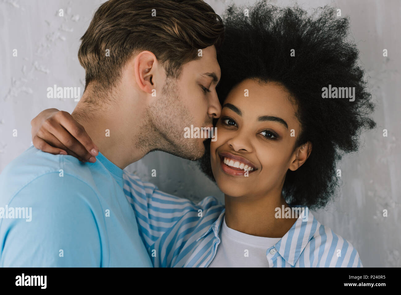 Tender man embracing and kissing african american girlfriend Stock ...