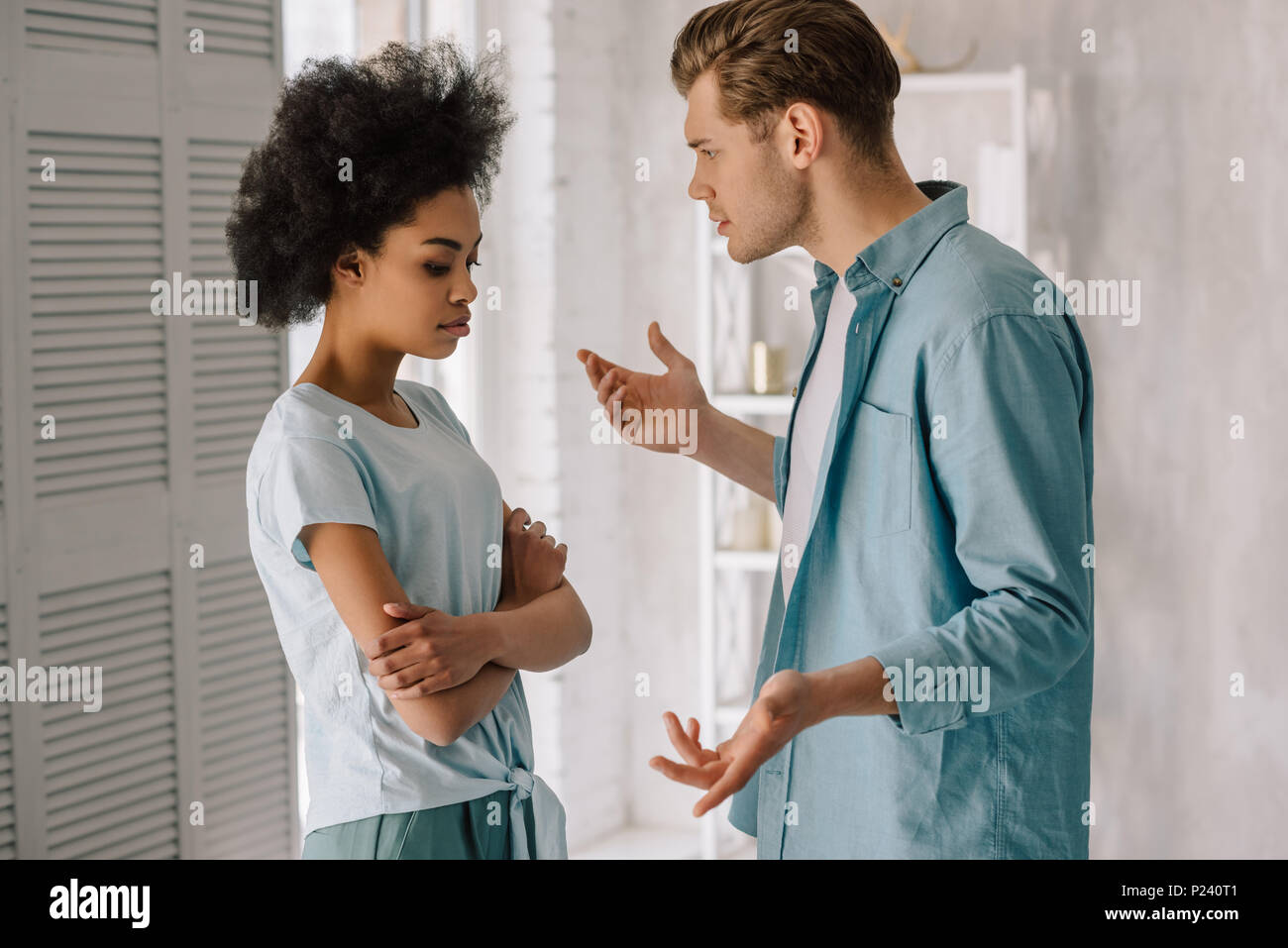 Multiracial couple having an argument at home Stock Photo - Alamy