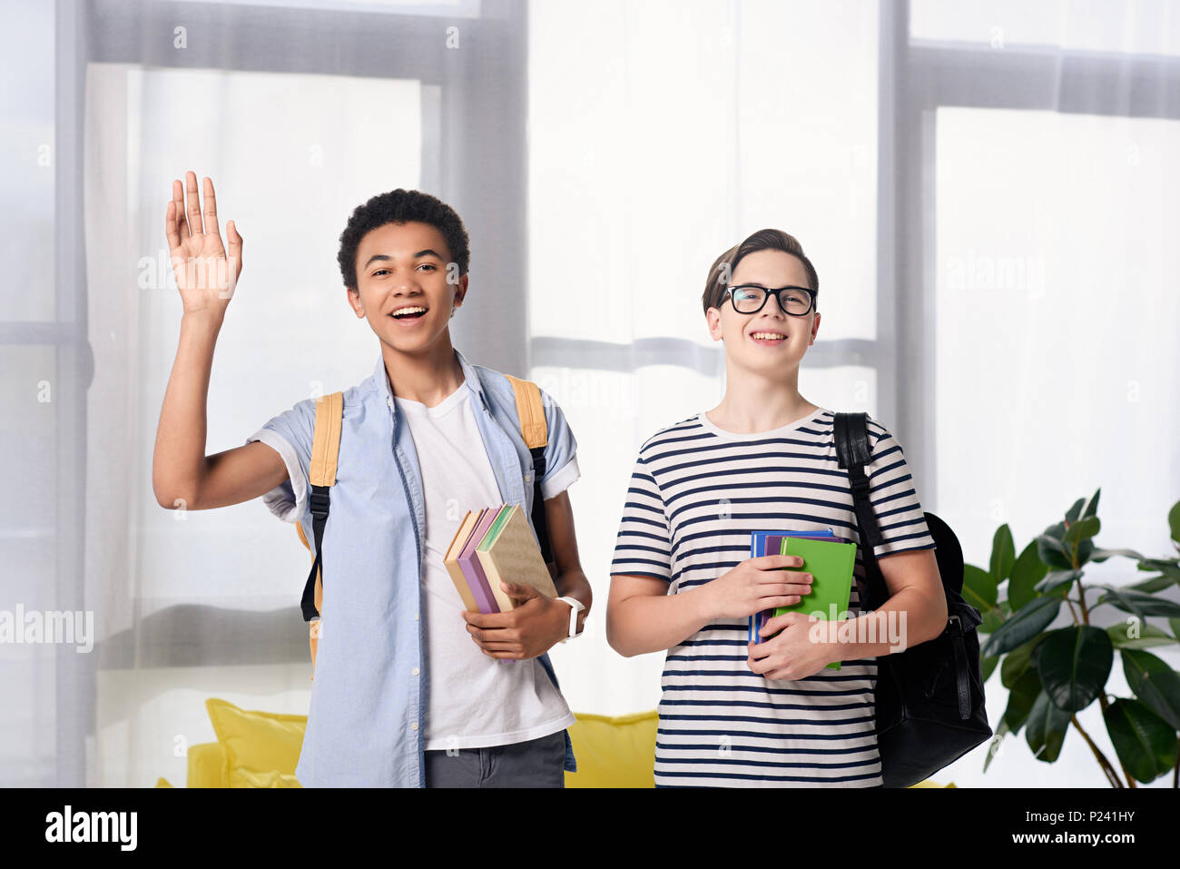 multicultural teen boys greeting someone at home Stock Photo - Alamy